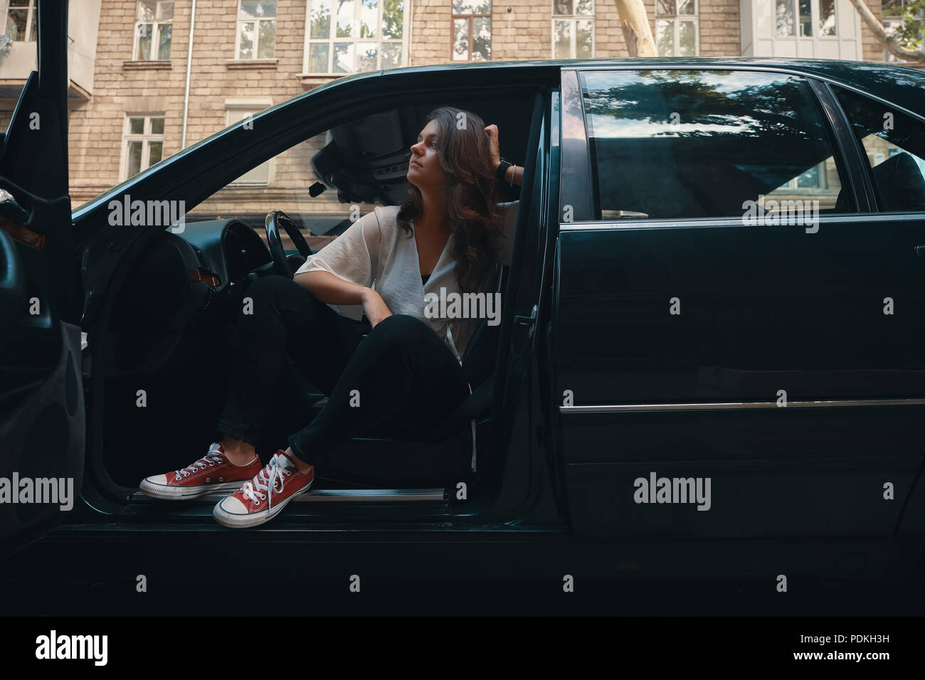 Woman getting into a car legs hi-res stock photography and images - Alamy