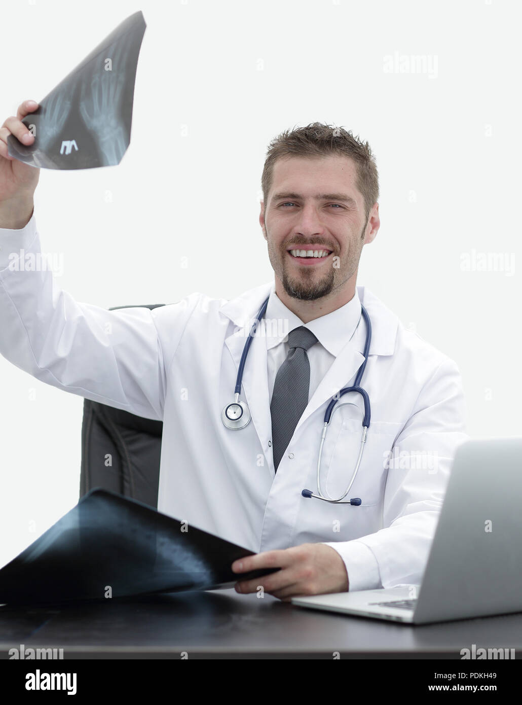 doctor examines an x-ray,sitting behind a Desk Stock Photo - Alamy