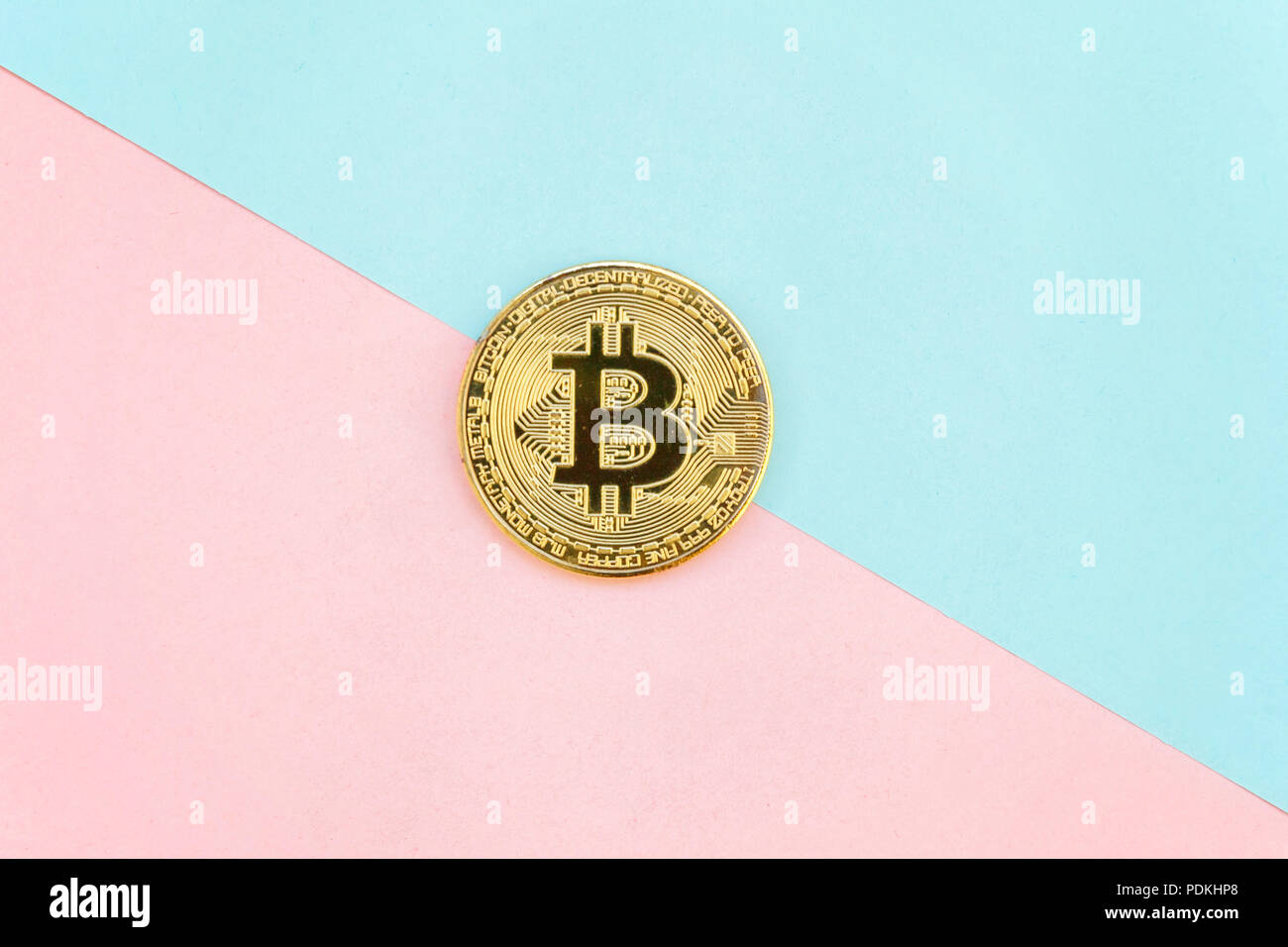 Gold bitcoin on on pink and blue pastel geometric background ...