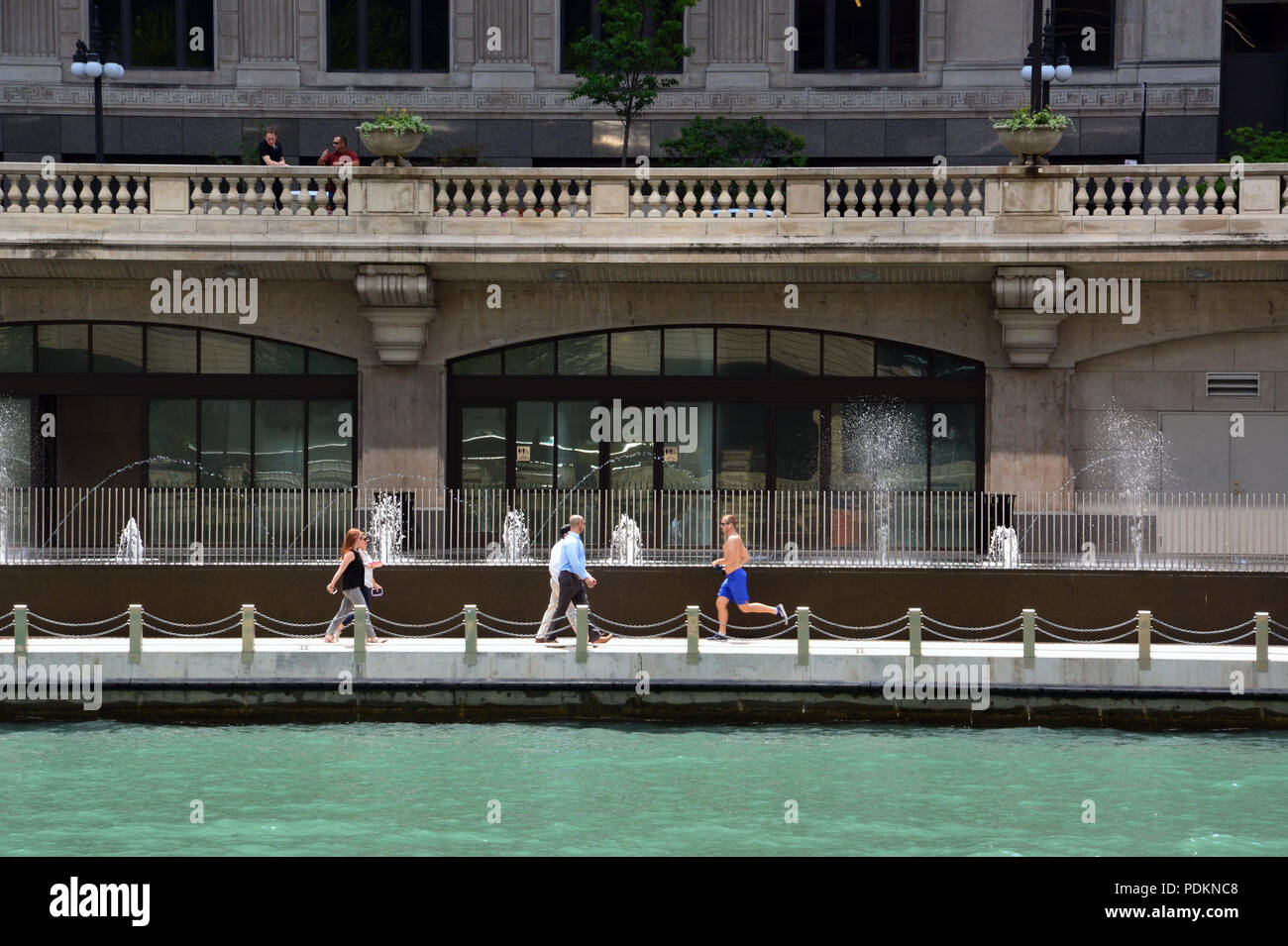 Walkers and runners share the Riverwalk on a summer day in downtown ...