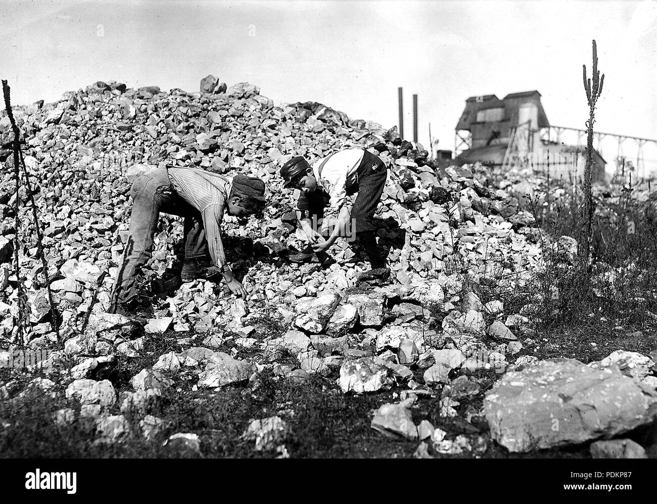 Two young boys collecting rocks, 1912 Stock Photo - Alamy