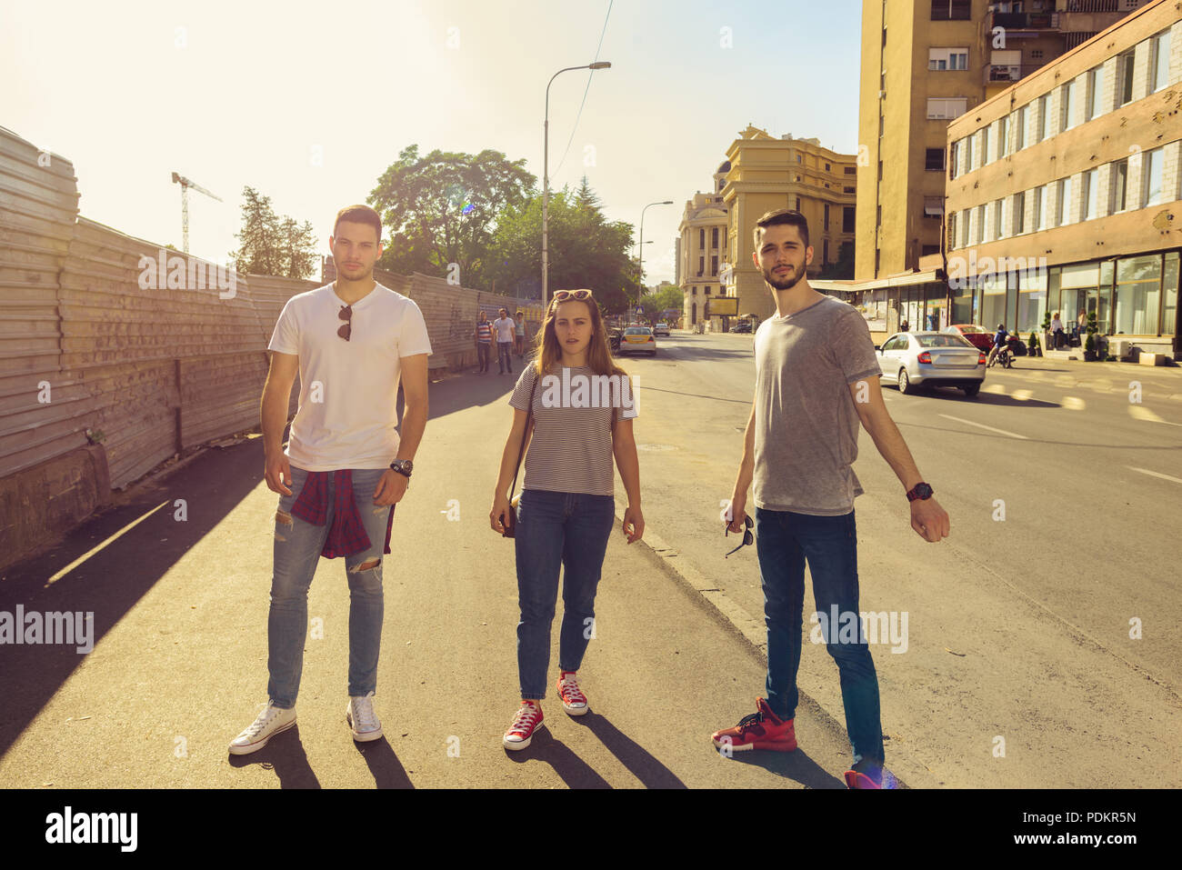 Group of young best friends having fun together walking on town street ...