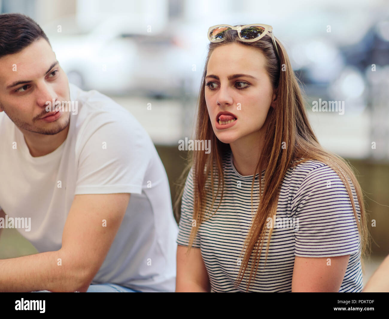 Positive three friends is talking while siiting on the bench Stock ...