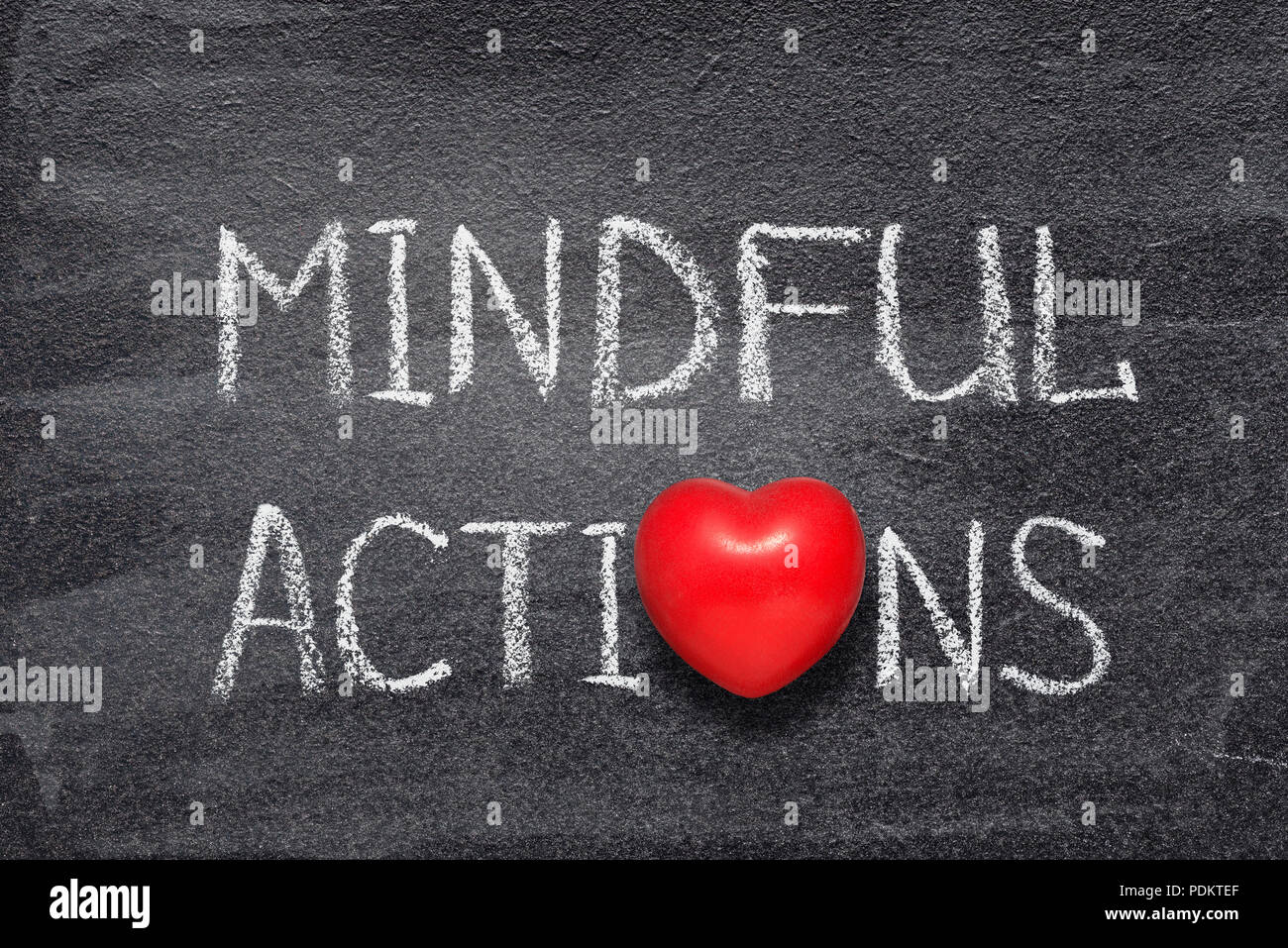 mindful actions phrase handwritten on chalkboard with red heart symbol ...
