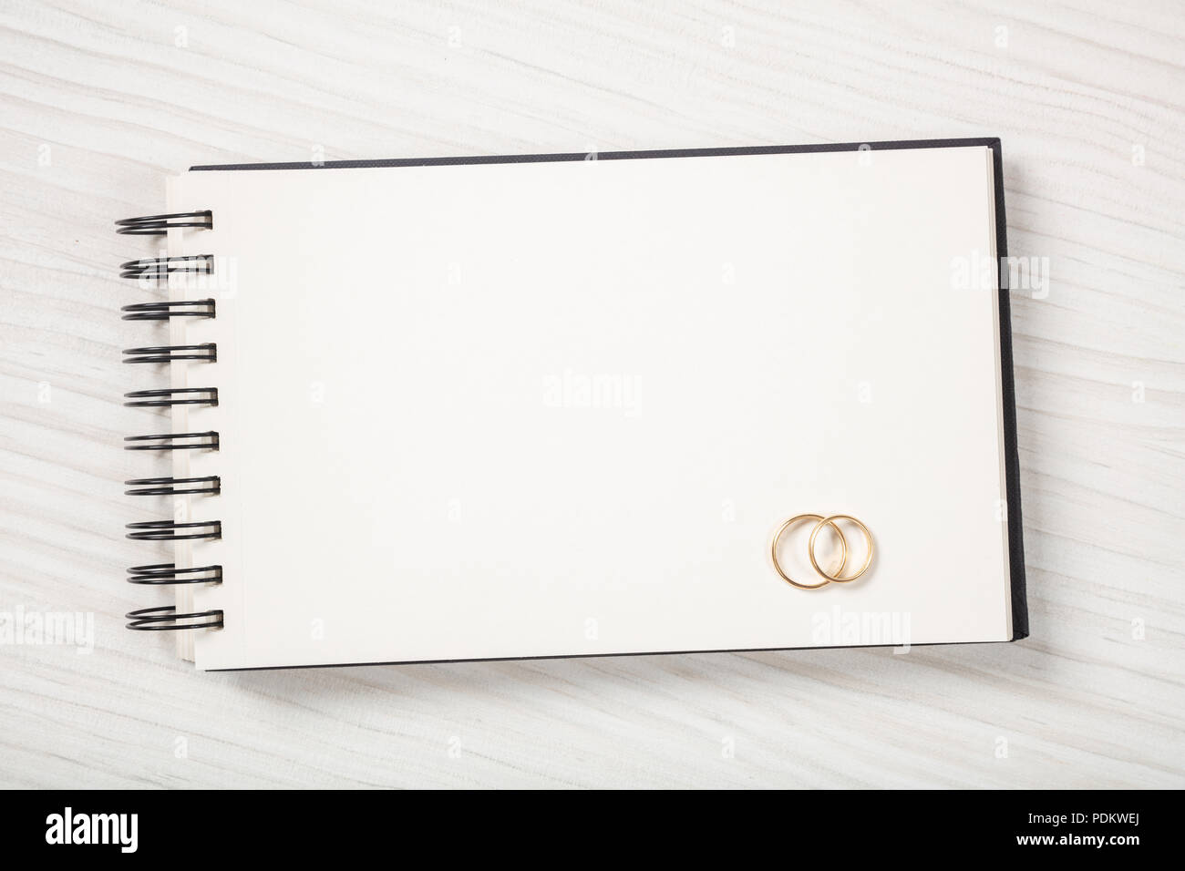 Love and marriage concept. Golden wedding rings on a blank notebook ...