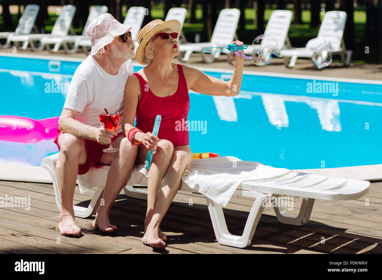 Couple of funny happy retired man and woman chilling under sun Stock ...