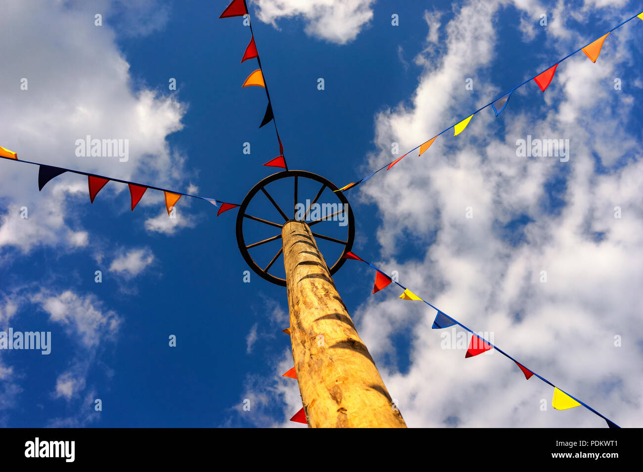 Flags on the rope to the wheel on a pole in the sky at the fair Stock ...