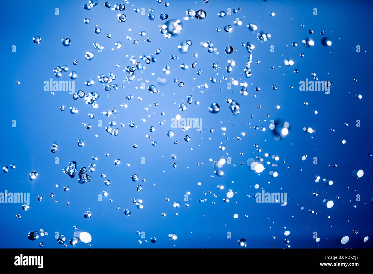 Close up of a water drops on a blue gradient background, covered with ...