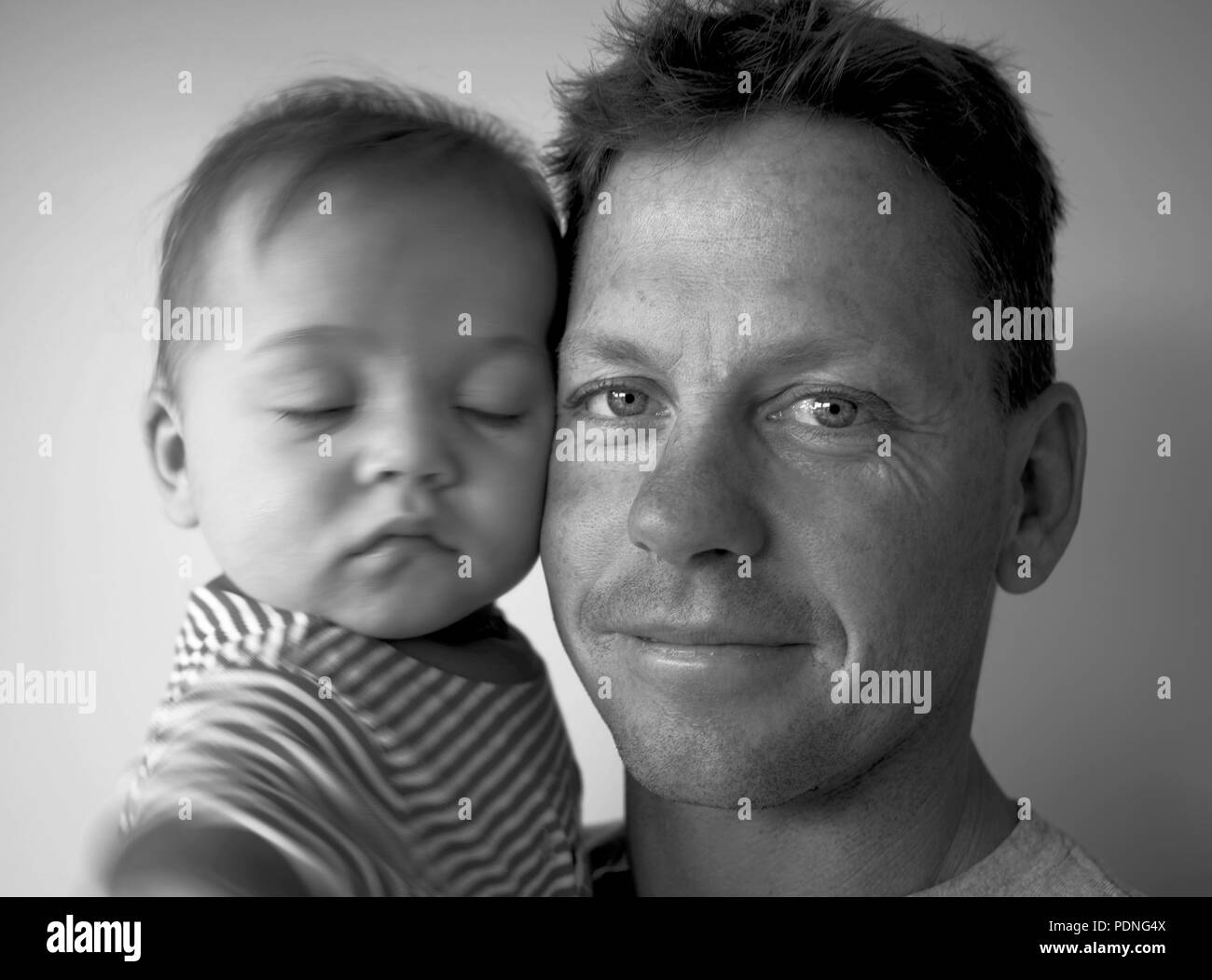 FATHER AND SLEEPY SON Stock Photo - Alamy