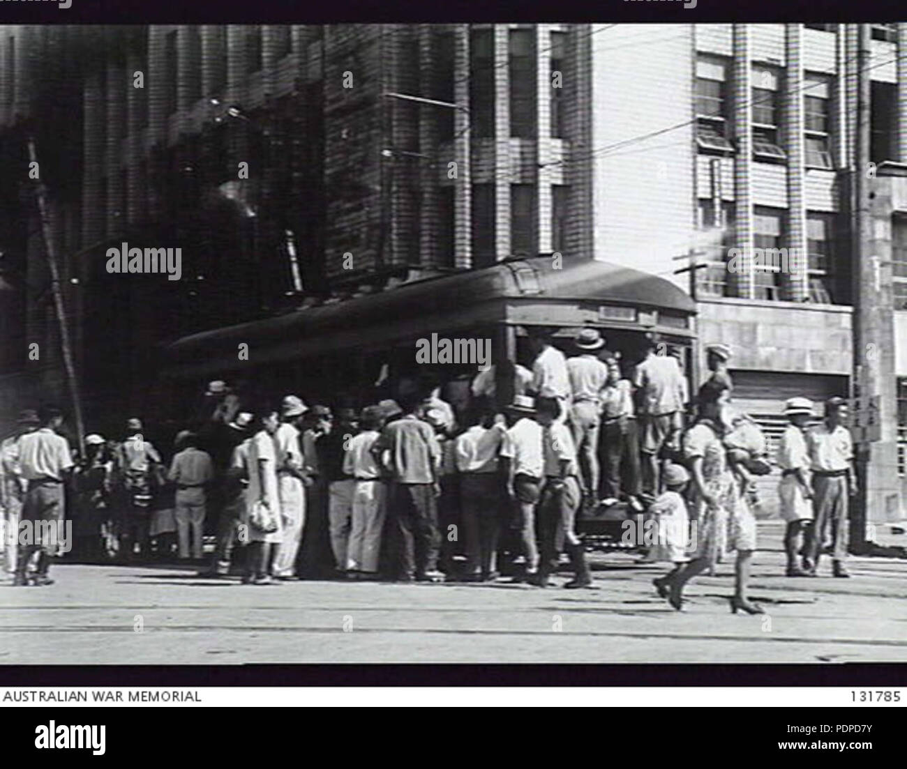 2 131785 JAPANESE CROWDING INTO AN ALREADY OVERCROWDED TRAM OUTSIDE THE ...