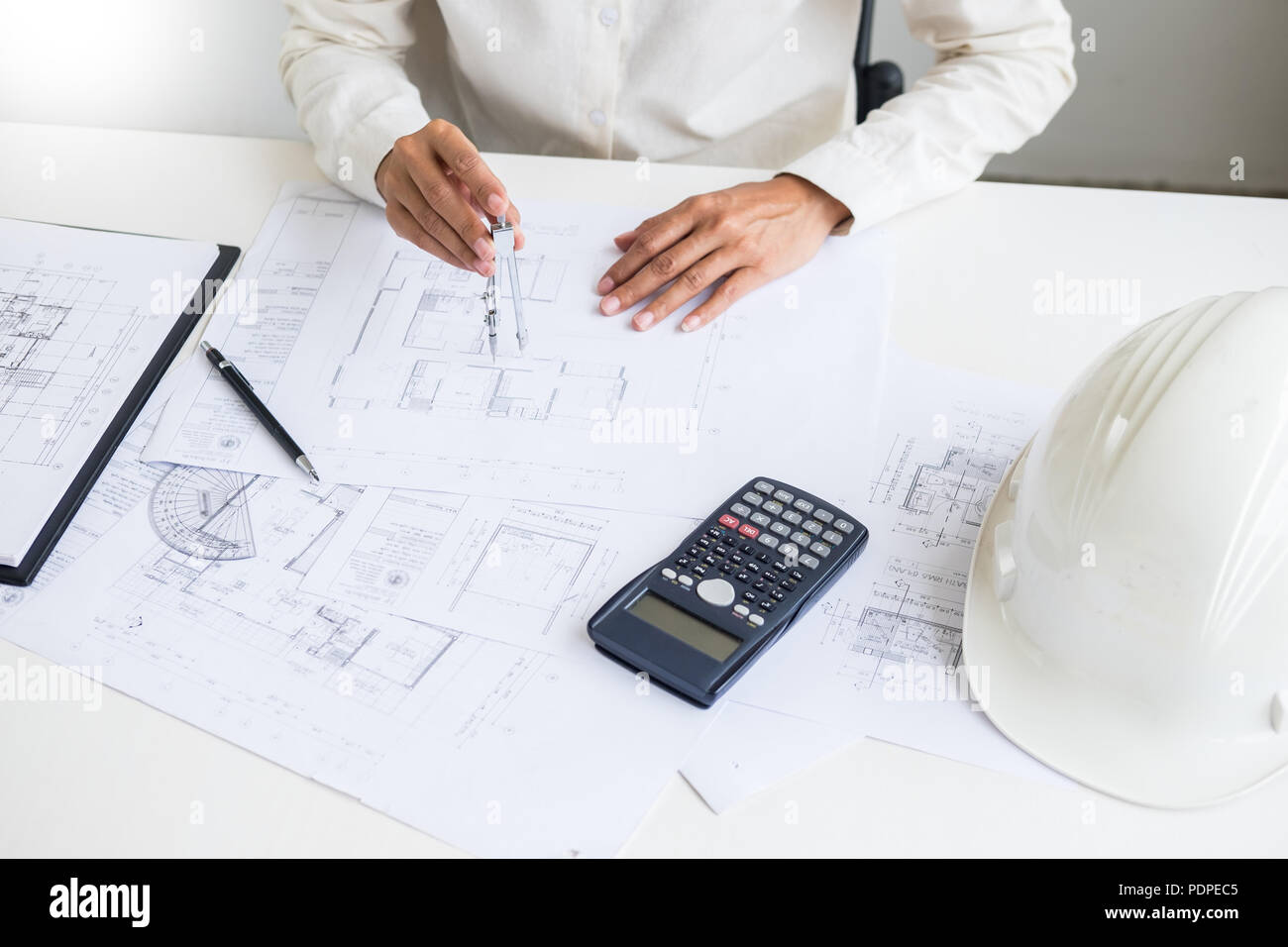 Close-up Of Person's engineer Hand Drawing Plan On Blue Print with ...