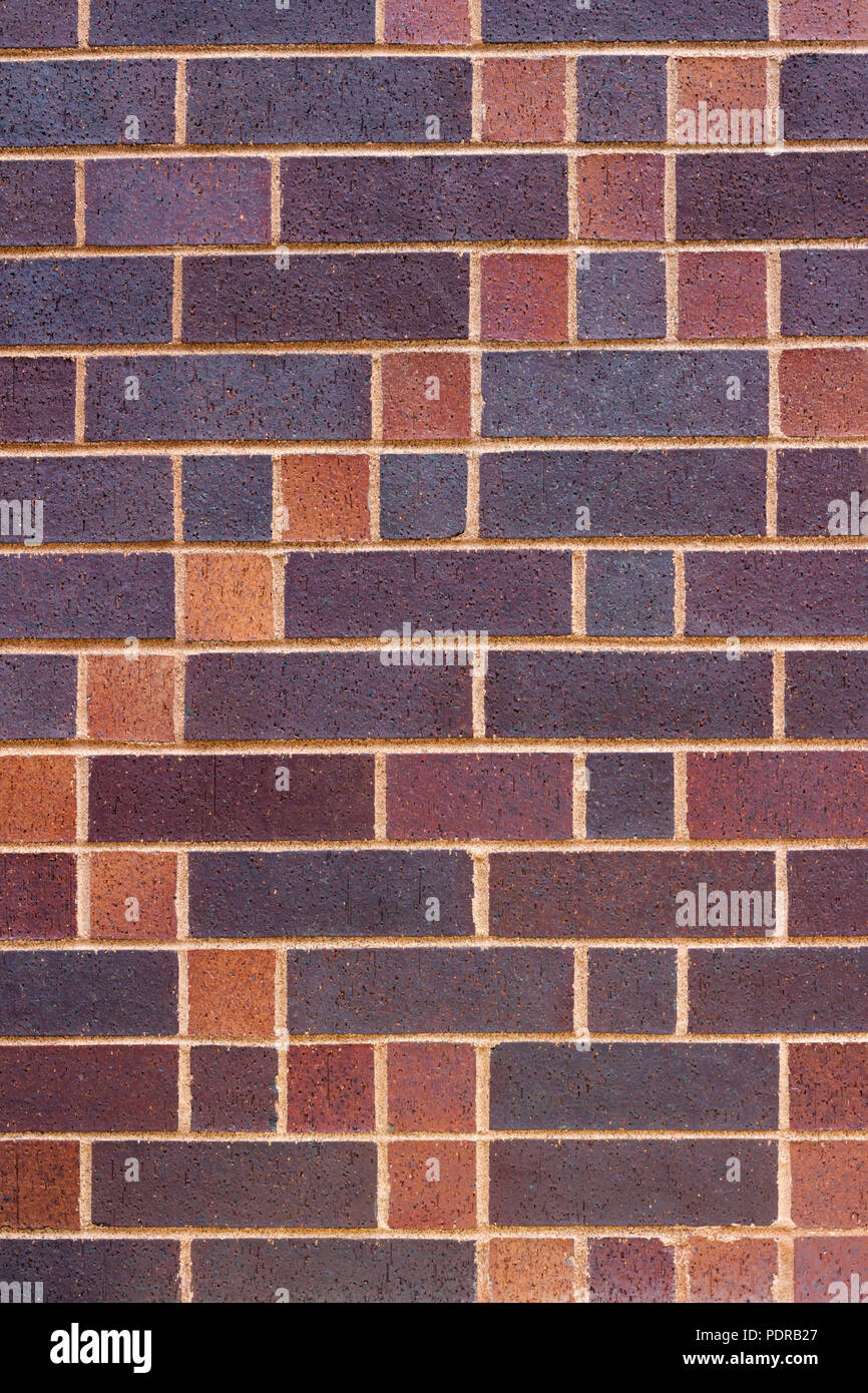 Vertical view of a brick wall background with a patchwork quilt design ...