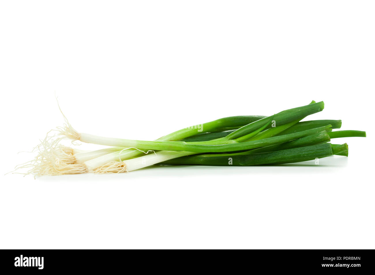 pile of spring onions isolated on white background Stock Photo - Alamy