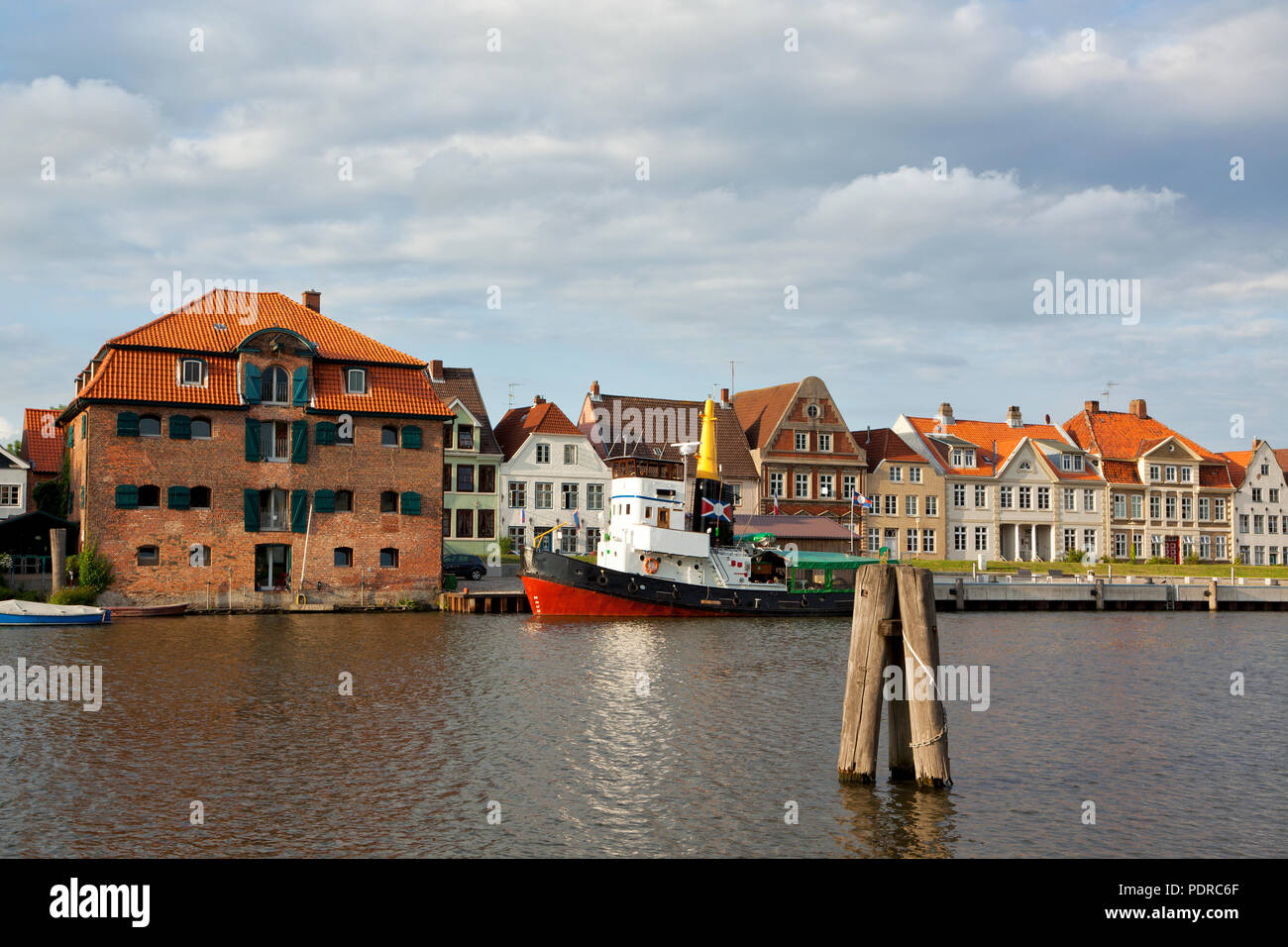 Historic salt warehouse and tug boat at waterfront of Glückstadt ...