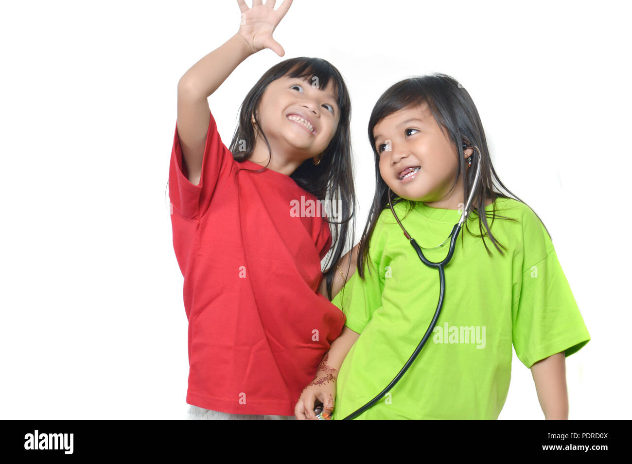 two asian little girl playing with a stethoscope Stock Photo - Alamy