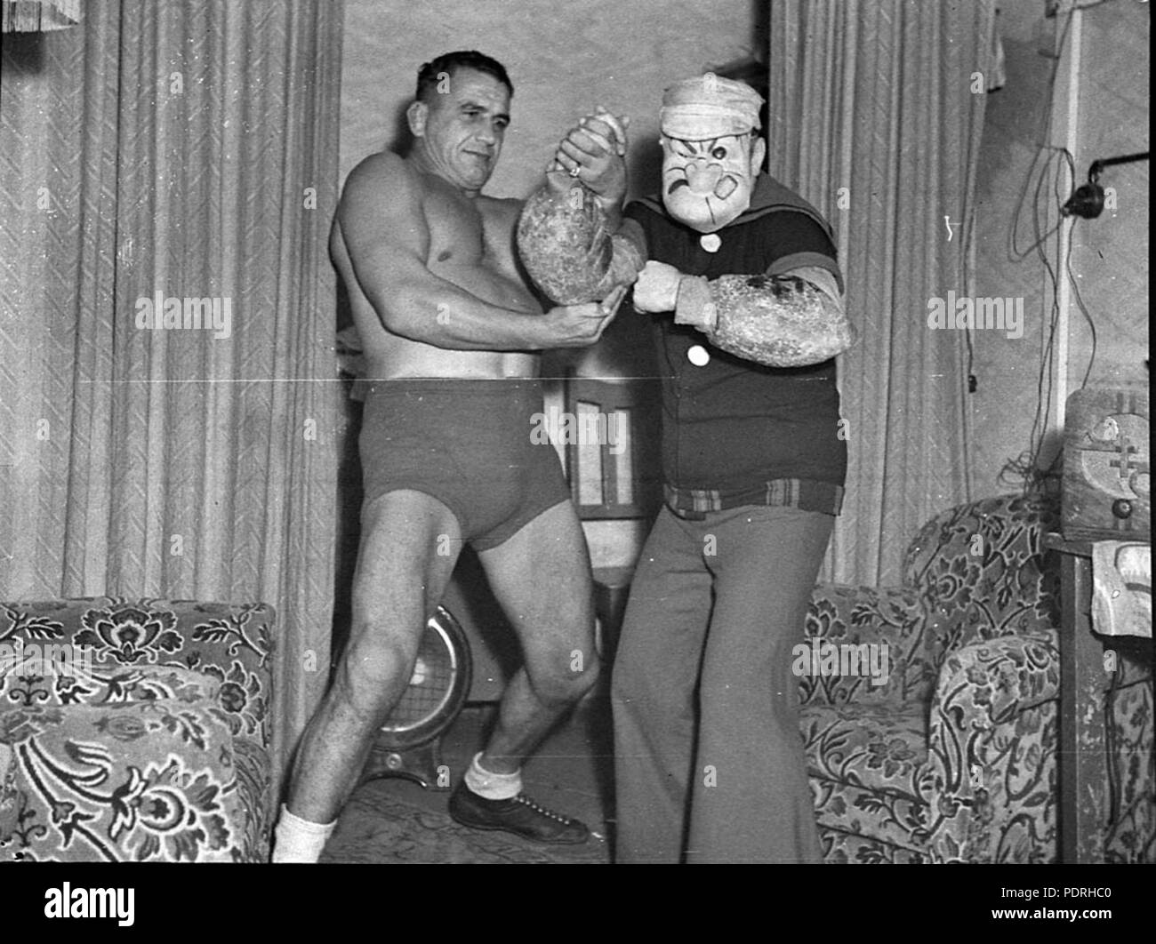 142 SLNSW 22547 Wrestler Ray Steele and cartoon character Popeye at the ...