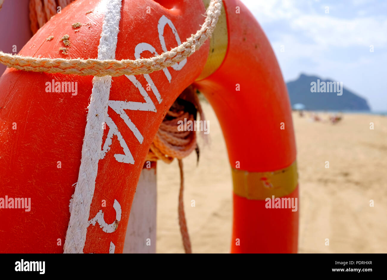 Lifebuoy on the pole on the beach side for thrown to a person in the ...