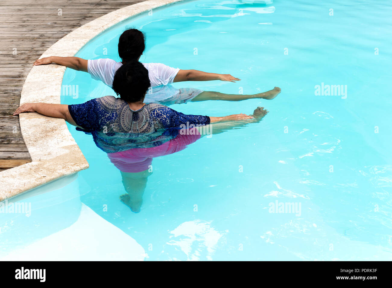 Two senior women doing aqua gym exercise in outdoor swimming pool Stock ...
