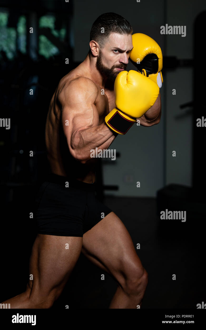 Handsome Man In Yellow Boxing Gloves - Boxing In Gym - The Concept Of A ...