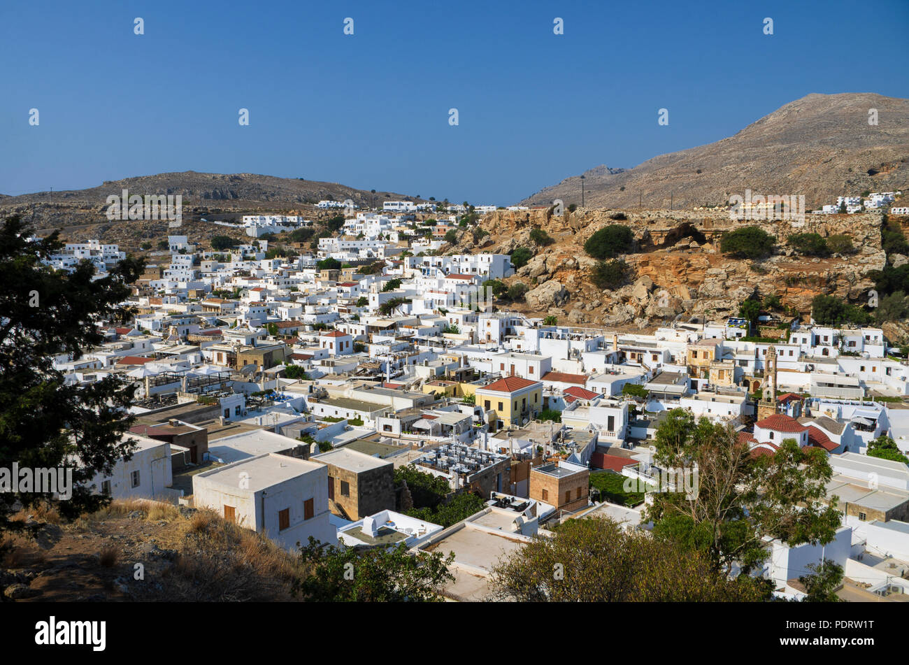 Beautiful panoramic view of Lindos with white roofs and blue sky ...