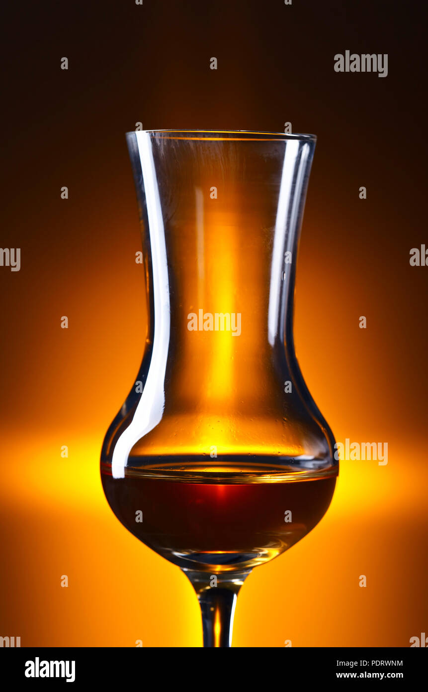 Glass of alcohol on a dark background Stock Photo - Alamy