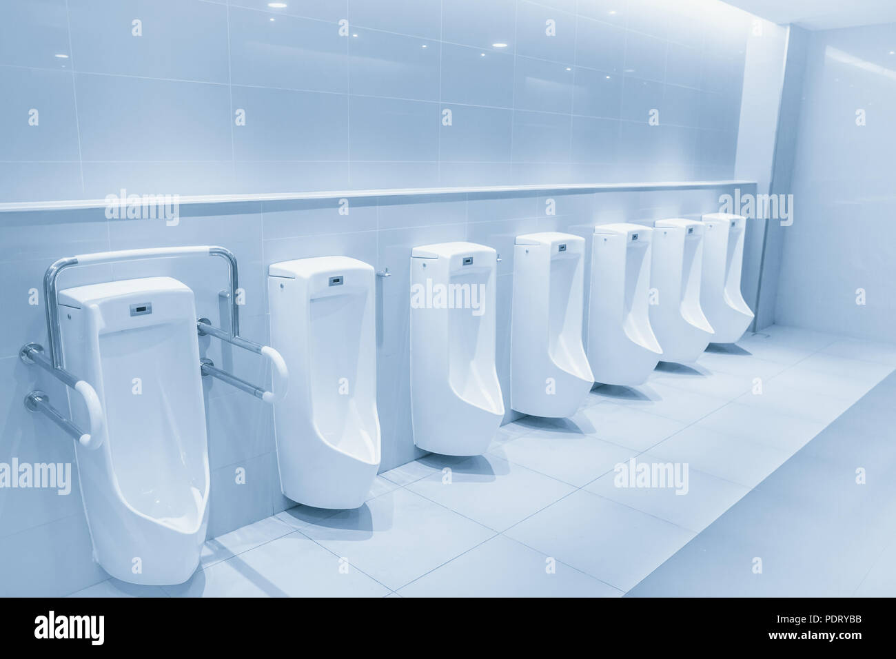 Clean male toilet row of urinals in a public restroom Stock Photo - Alamy