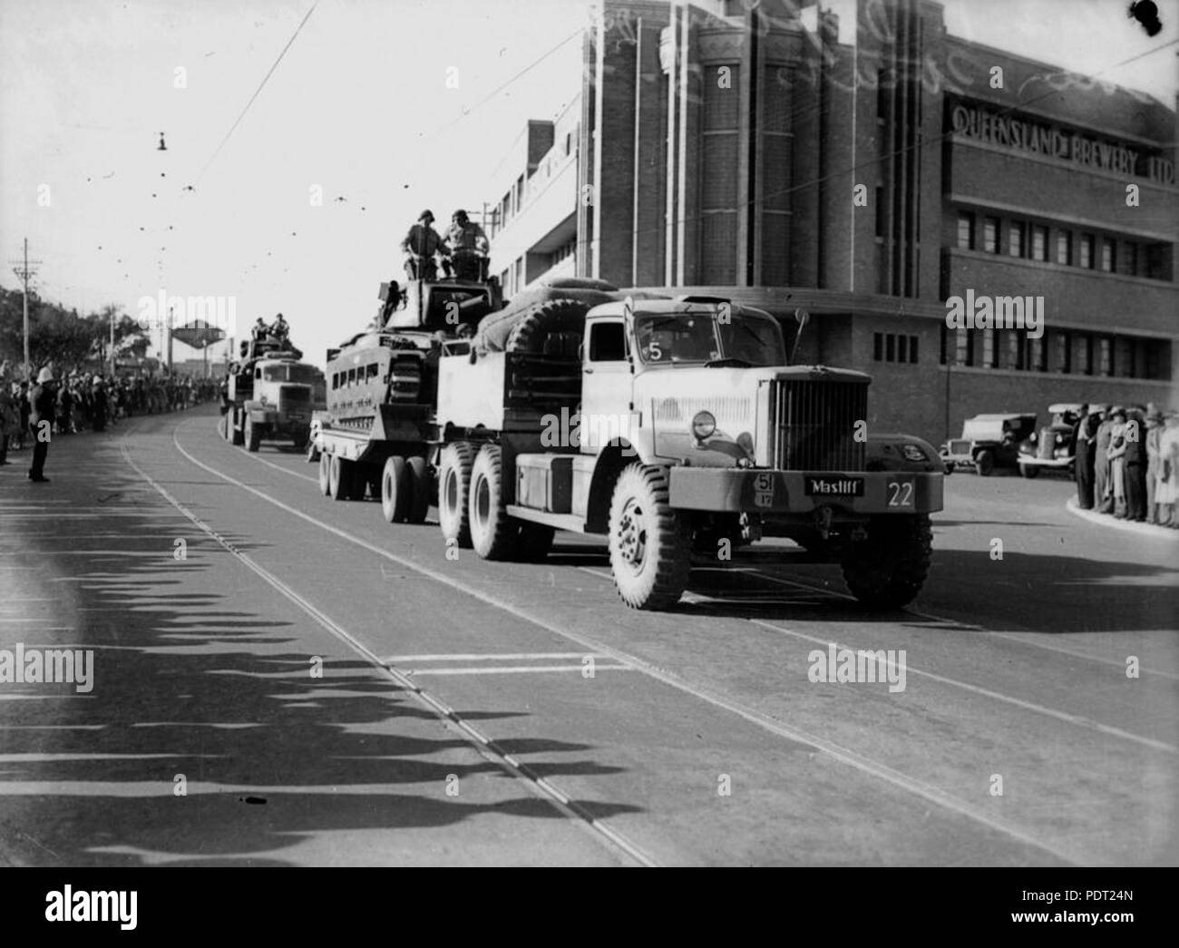202 StateLibQld 1 106588 Parade of military vehicles through the ...