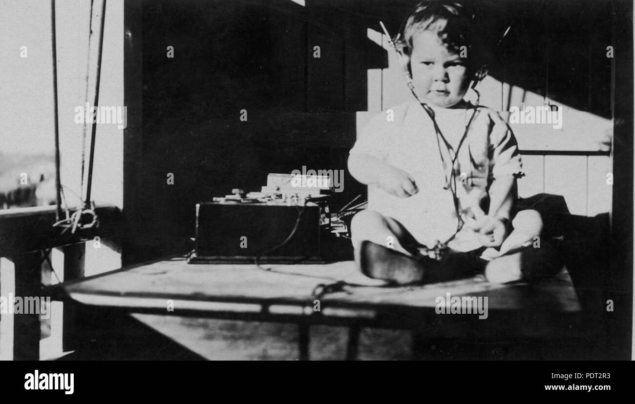 208 StateLibQld 1 115508 Young child listening to a radio, 1920-1930 ...
