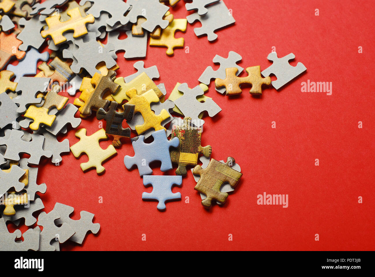 jigsaw puzzle pieces random arranged over a red background Stock Photo ...