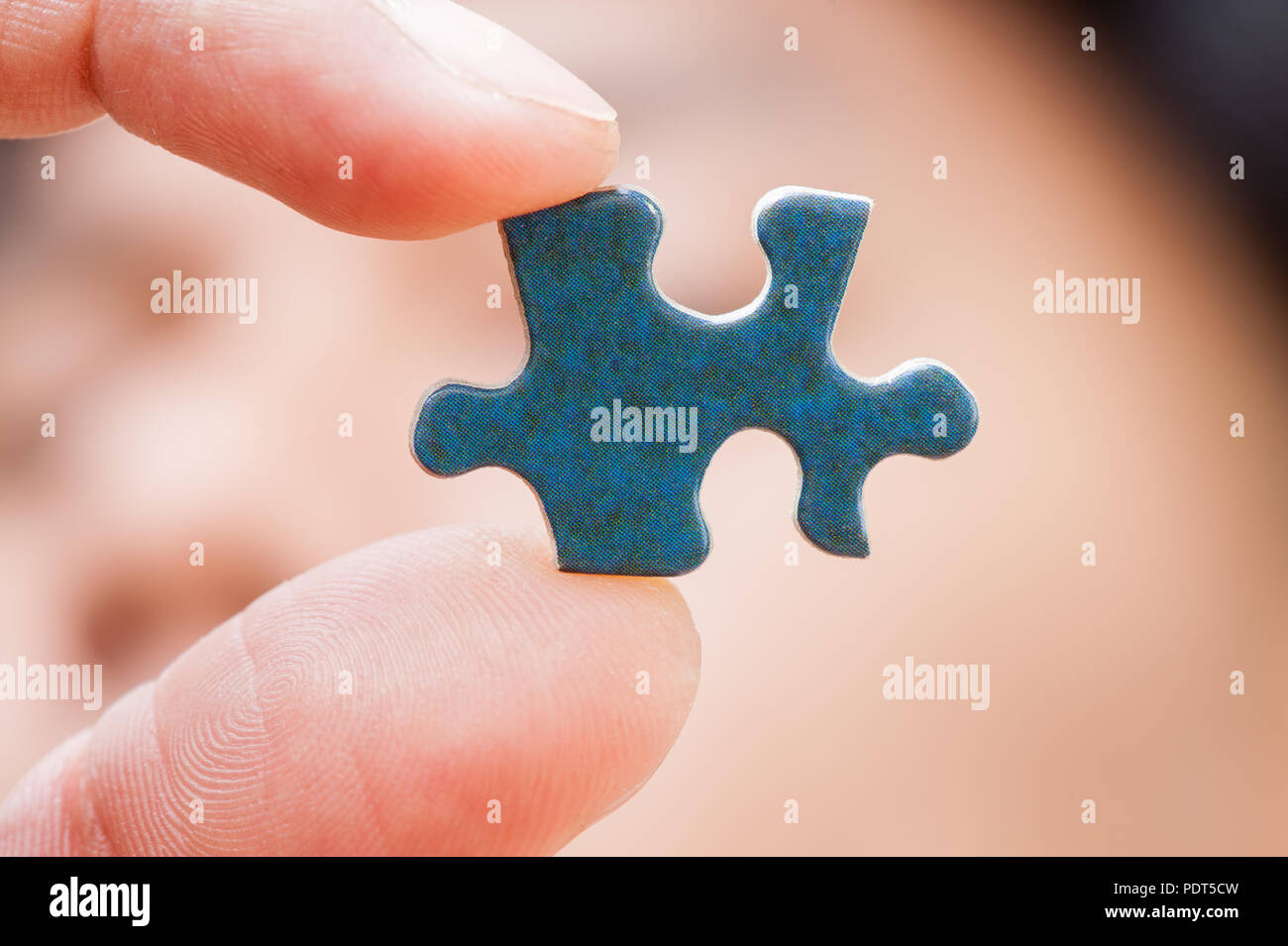 closeup the last blue jigsaw puzzle in hand Stock Photo - Alamy