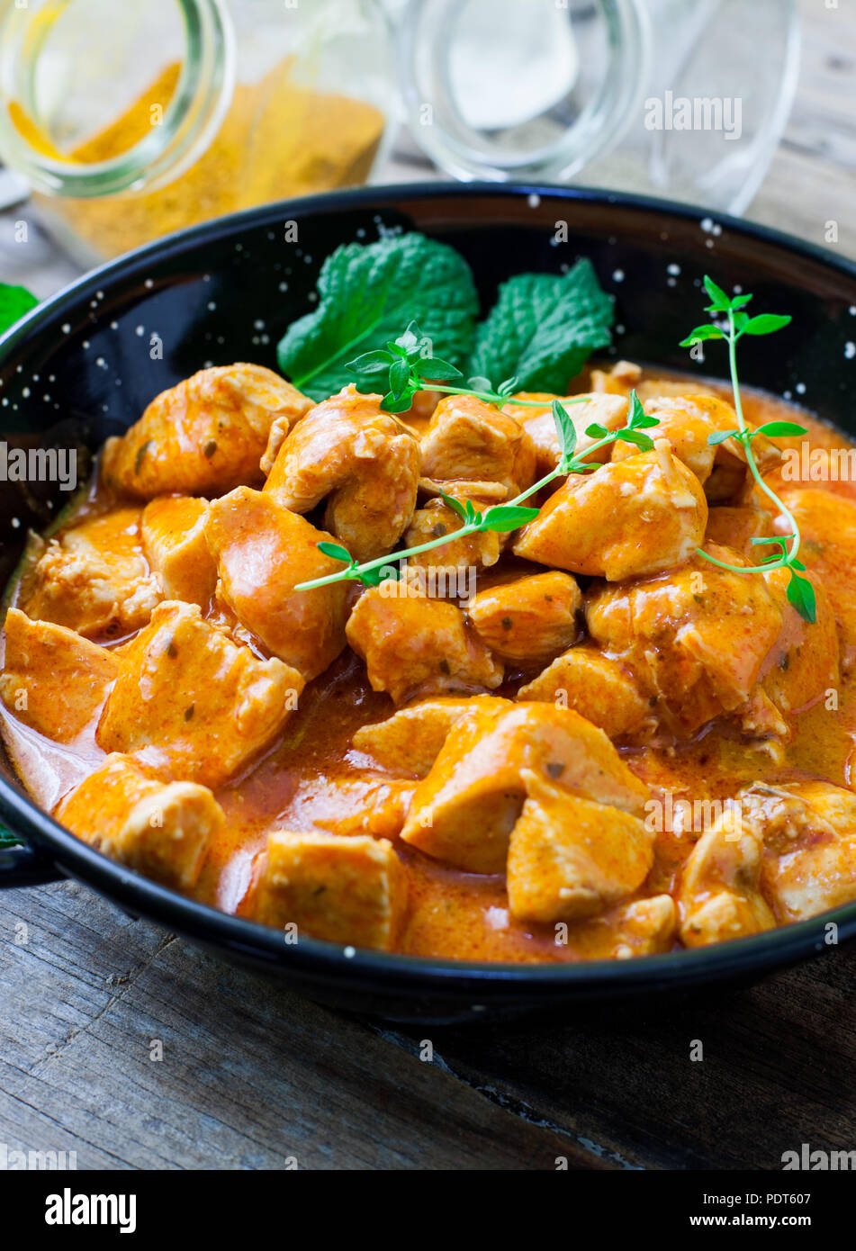 Indian chicken tikka masala curry with herbs Stock Photo - Alamy