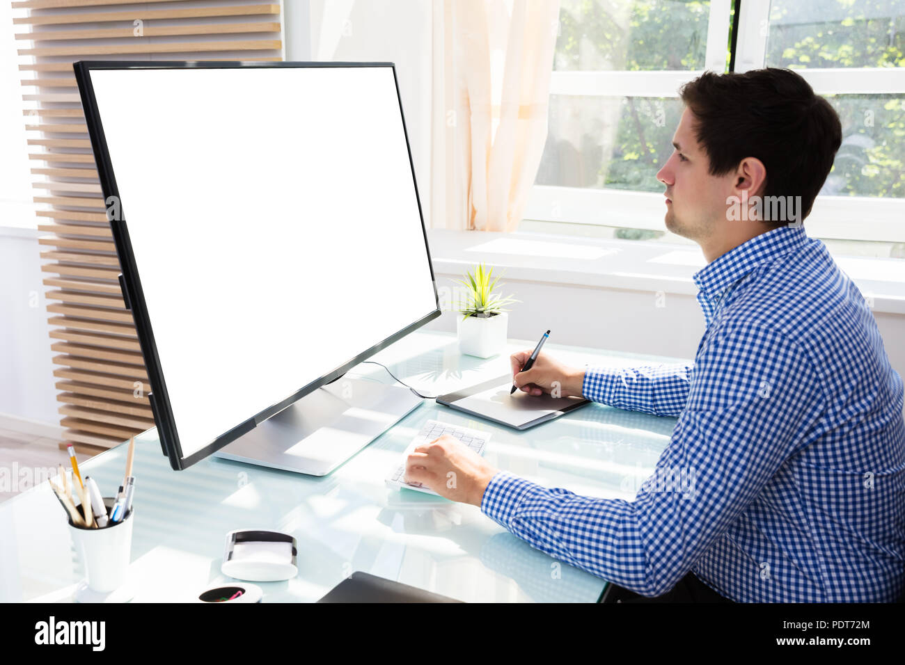 Businessman using computer with blank white screen Stock Photo - Alamy