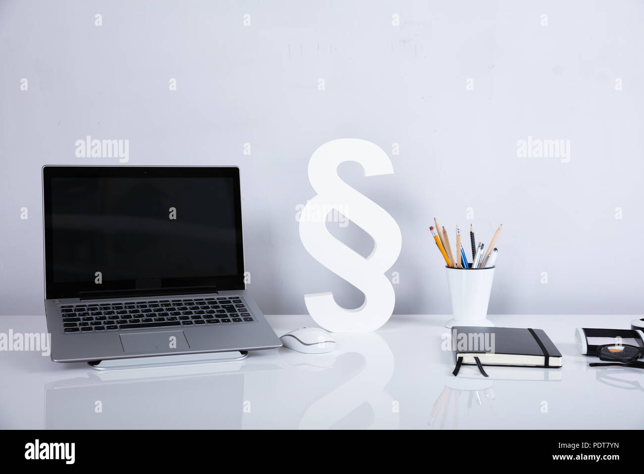 Laptop With Blank Screen And White Paragraph Symbol On Reflective Desk ...