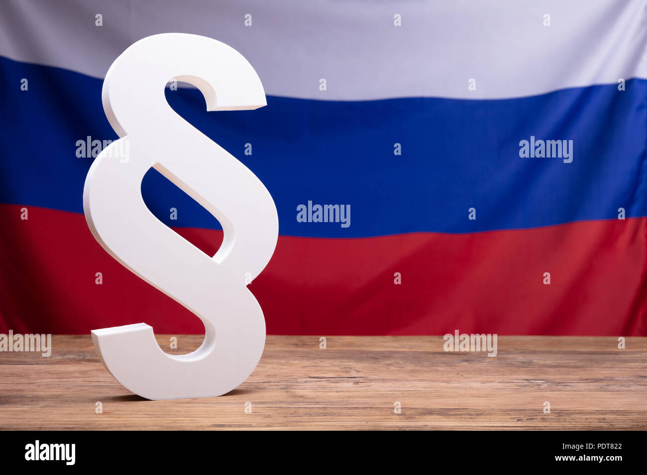 Close-up Of White Paragraph Symbol On Wooden Desk In Front Of Russian ...