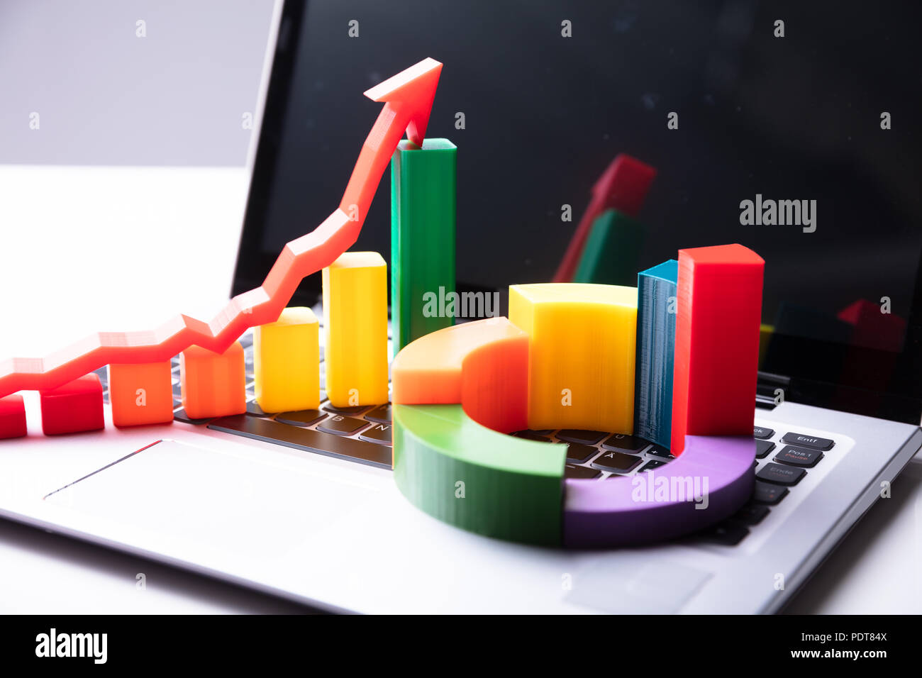 Close-up Of Two Different Colorful Charts On Laptop Keypad Stock Photo ...