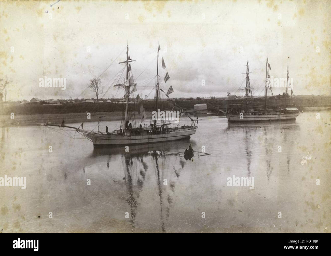 258 StateLibQld 1 257660 Schooner on the river with sails down and ...