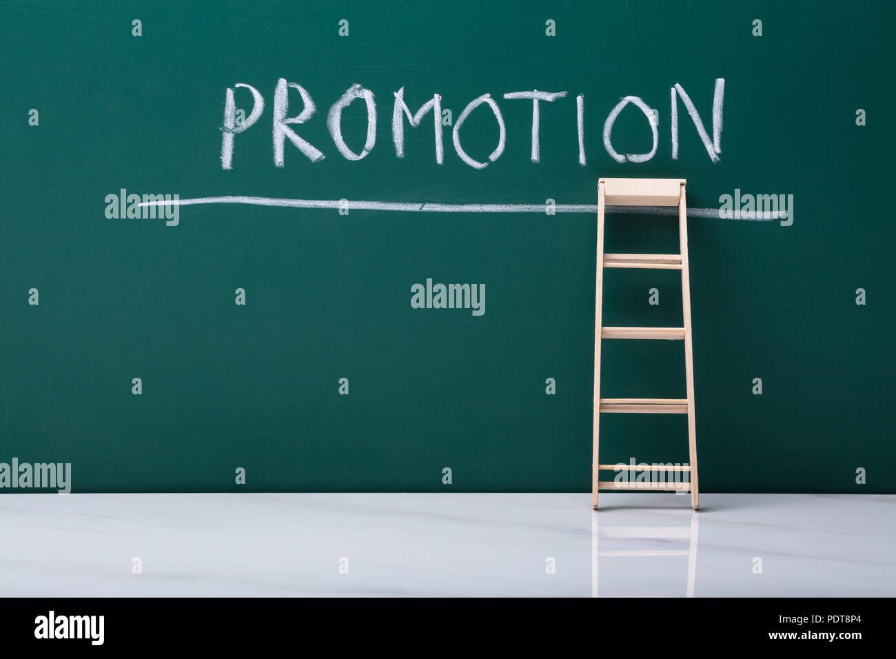 Wooden Ladder Leaning On Chalkboard With Promotion Word Stock Photo - Alamy