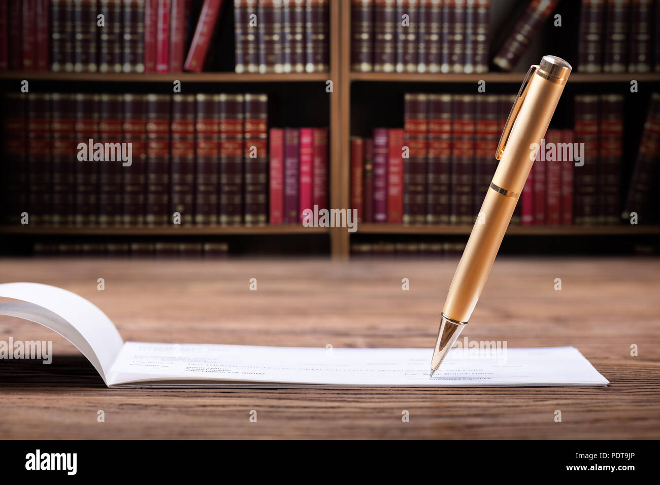Photo Of Golden Pen Signing Cheque In Courtroom Stock Photo - Alamy