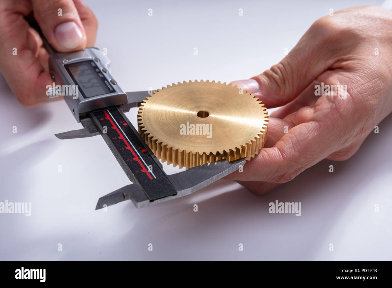 A Person's Hand Measuring Gear's Size With Digital Electronic Vernier ...