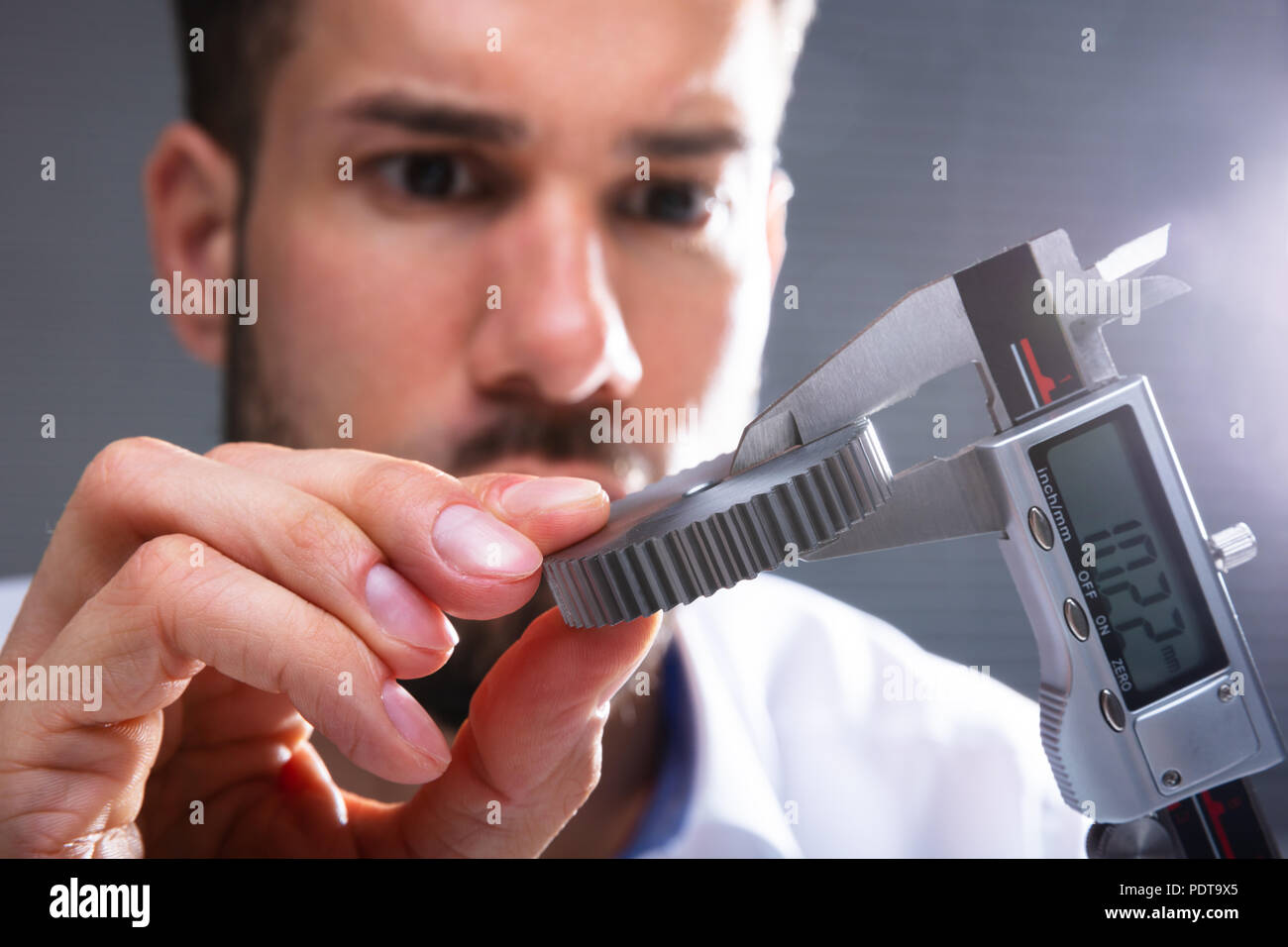 Close-up Of A Man's Hand Measuring Gear's Size With Digital Electronic ...