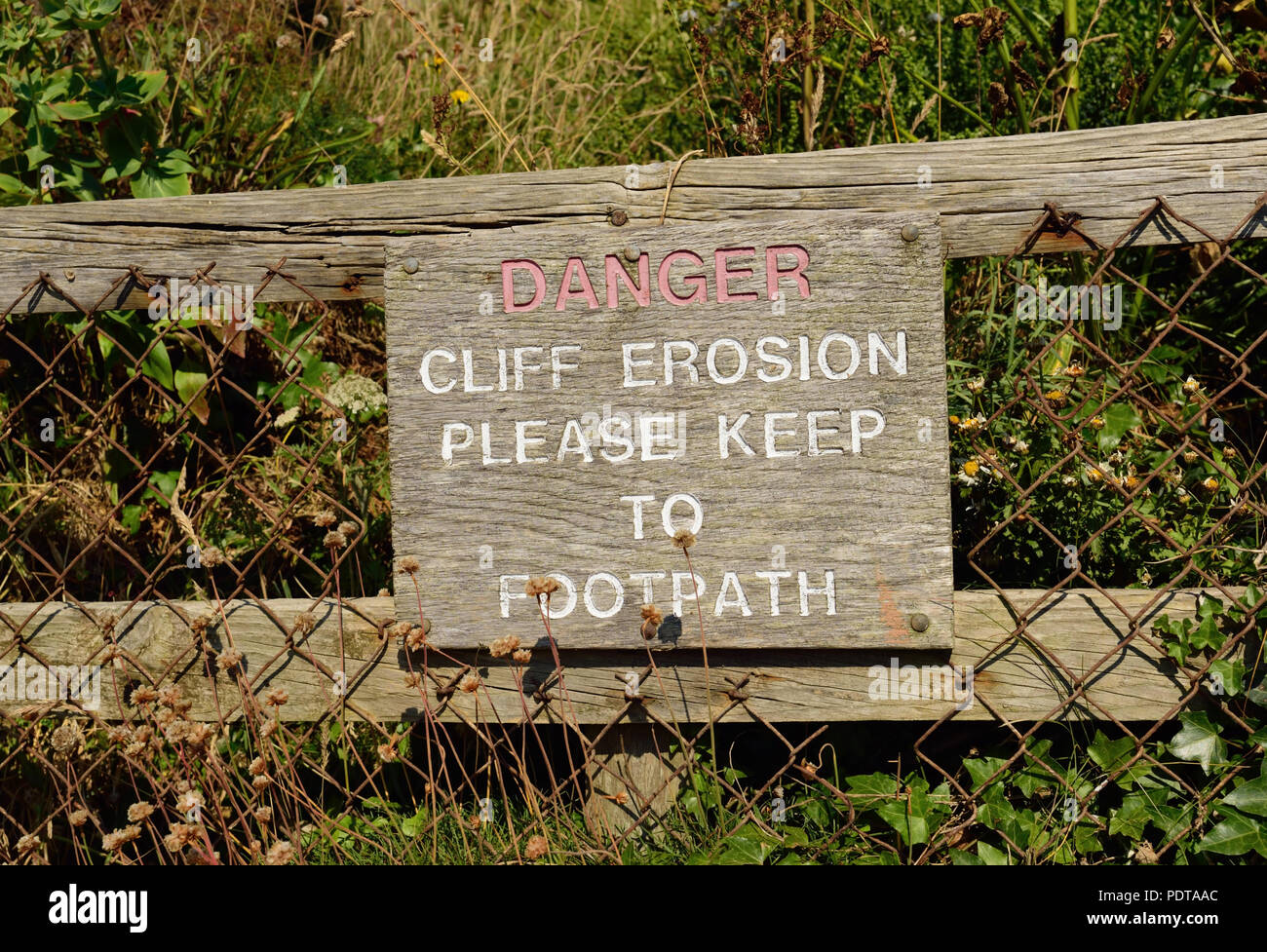 Warning sign about cliff erosion along the South West Coast Path at ...