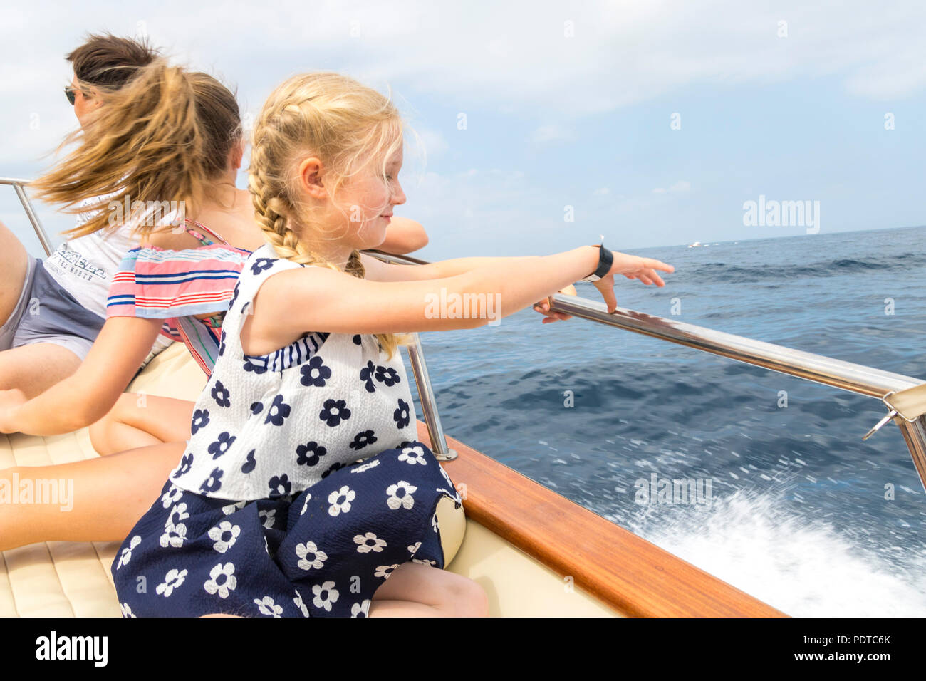 Excited, happy Girl, kid, child, sitting on a yacht, cruise boat ...