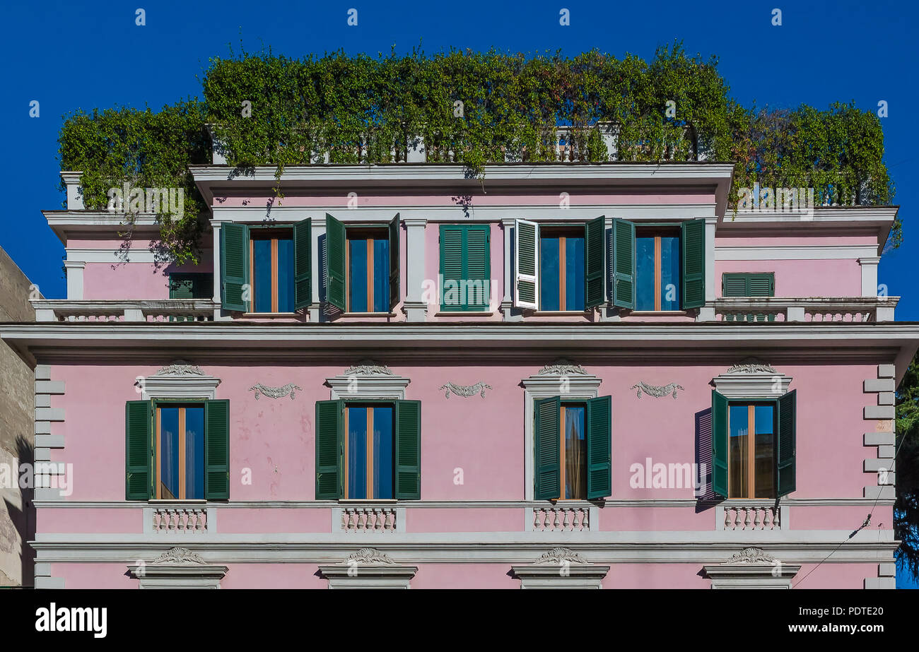 Rows of old windows with shutters on an ornate facade of an apartment ...