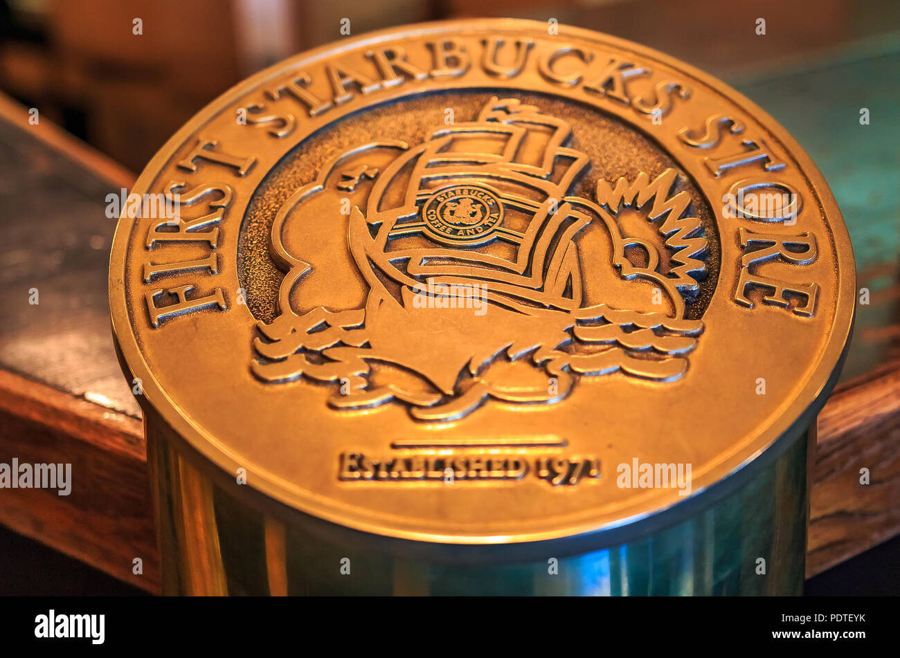 Seattle, USA - February 26, 2017: Bronze logo at the original Starbucks ...