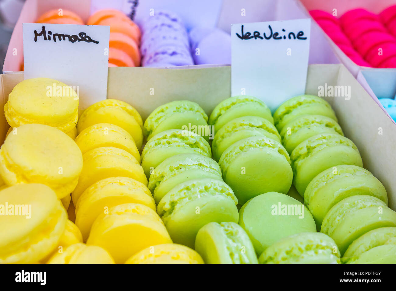 Colorful macarons in boxes for sale at a market stall in Southern ...