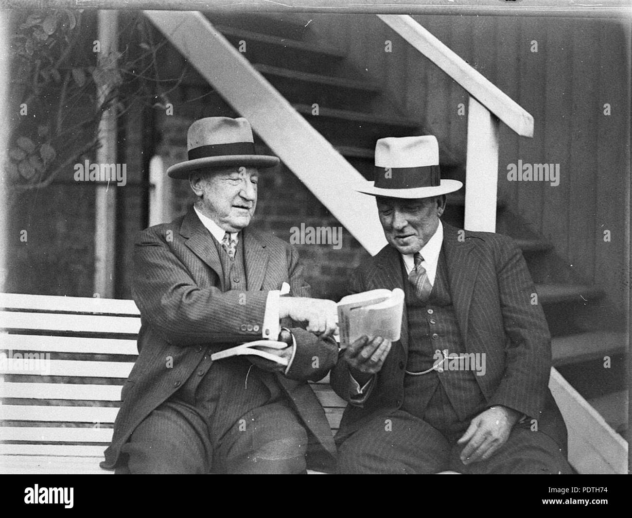 169 SLNSW 51569 Two unidentified cattlemen studying their catalogue ...