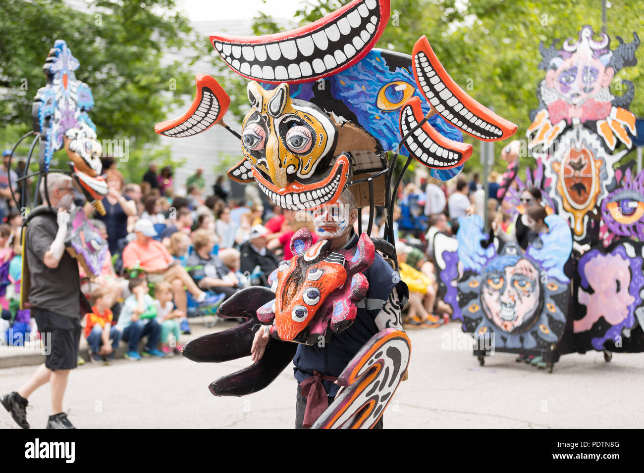 Cleveland, Ohio, USA - June 9, 2018 man wears a costume with faces and ...