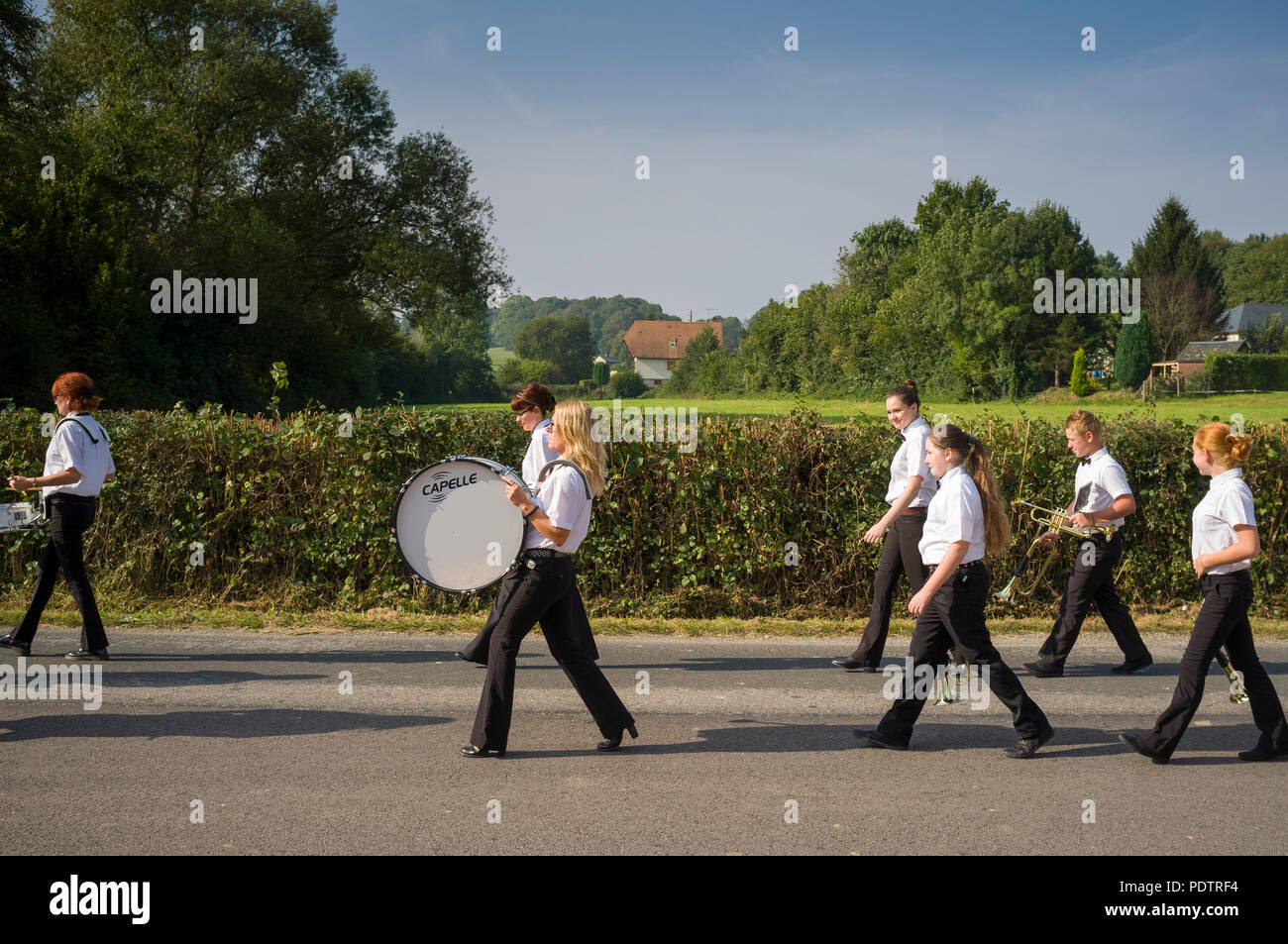A village marching band parade in St. Pierre de Cormeilles, Normandy ...