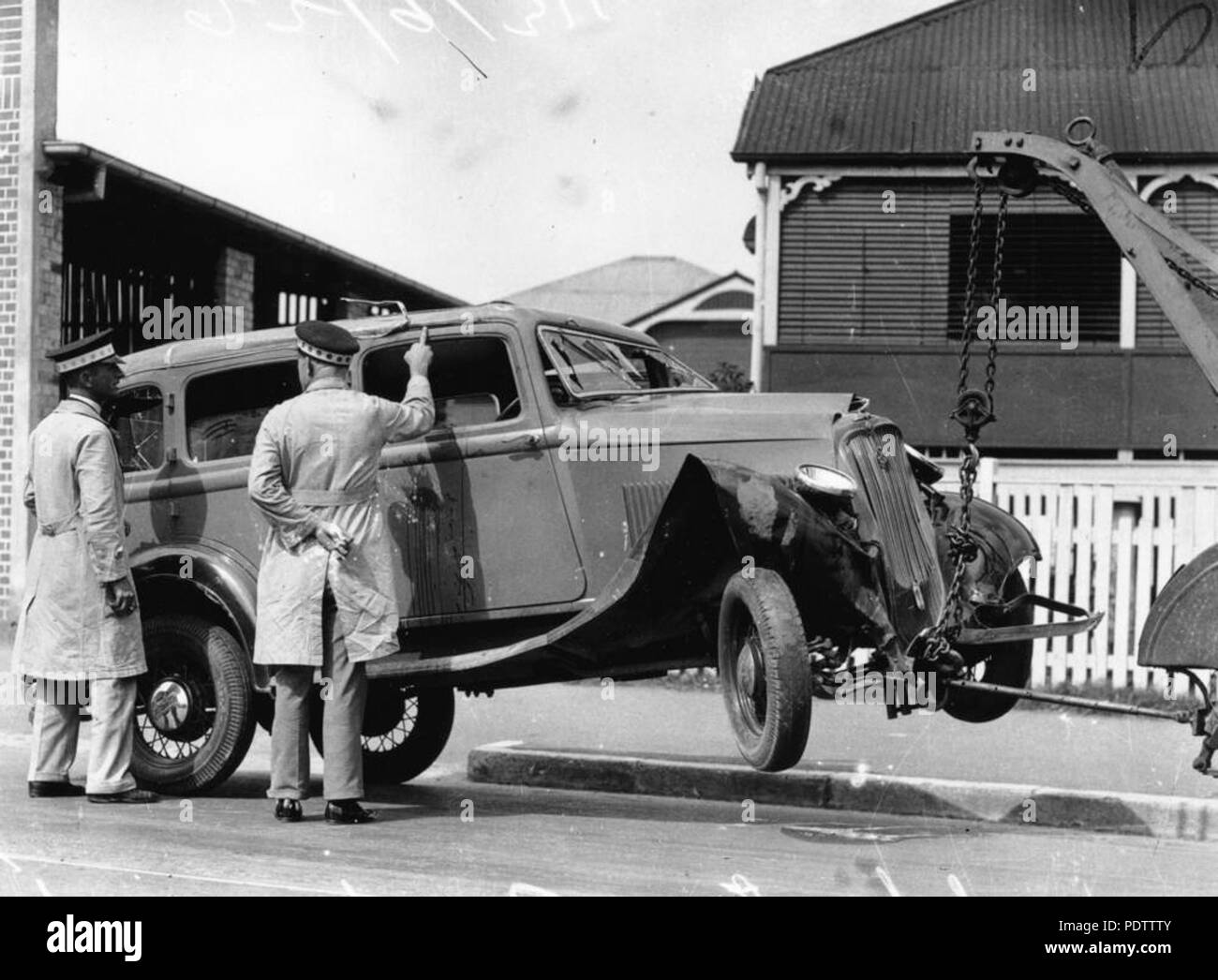 206 StateLibQld 1 112700 Tow truck moving a 1933 Continental Sedan ...