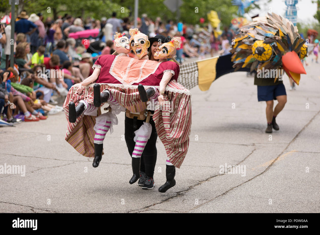 Cleveland, Ohio, USA - June 9, 2018 a young woman carries a trio of ...
